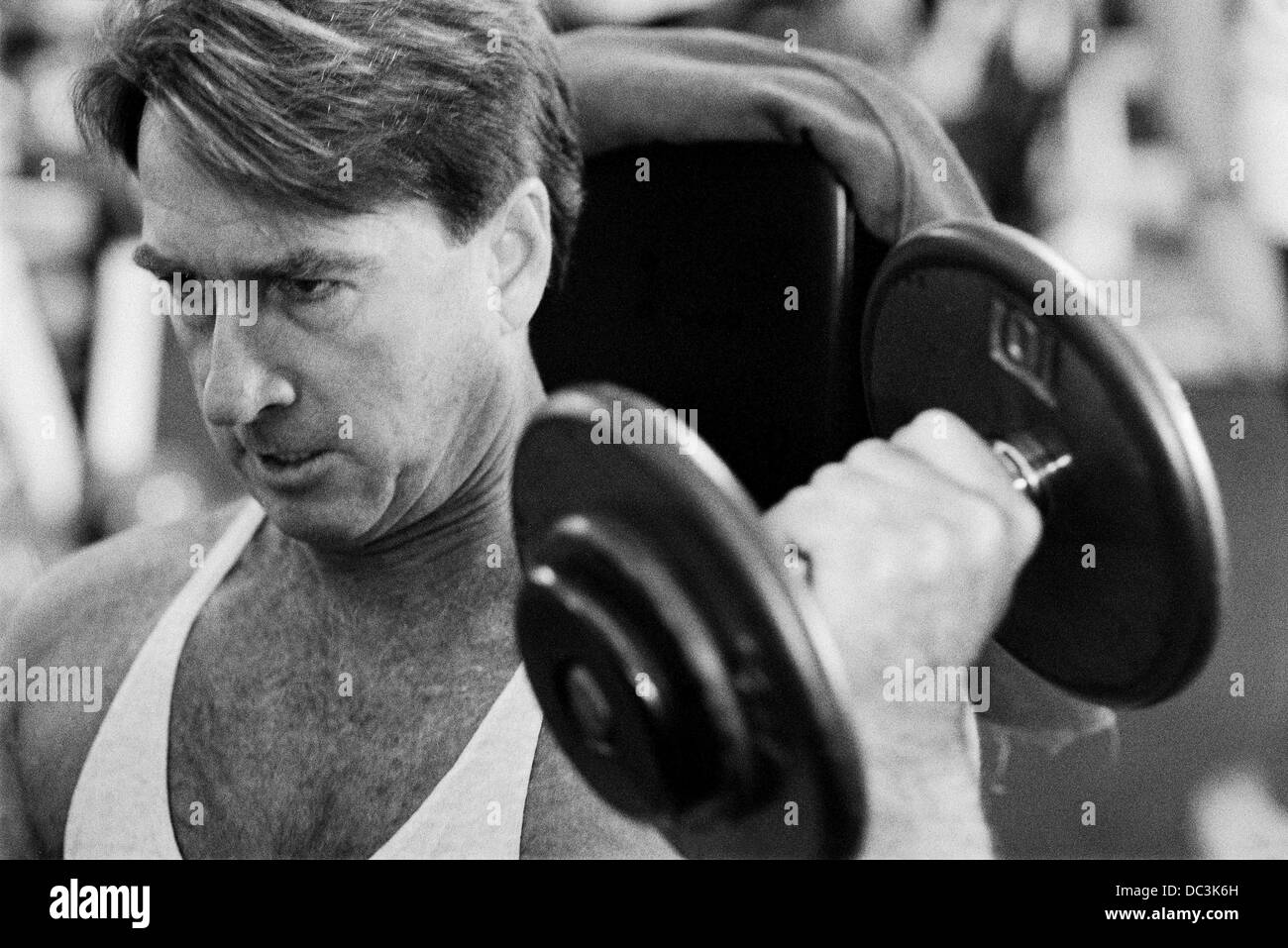Middle aged man lifting hand weight Stock Photo - Alamy