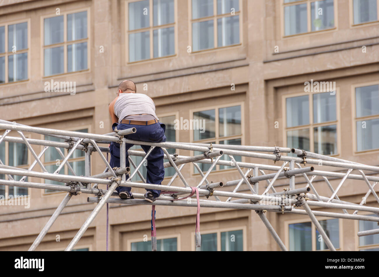 Stage rigger, technician, rigging up a truss for a public event ...