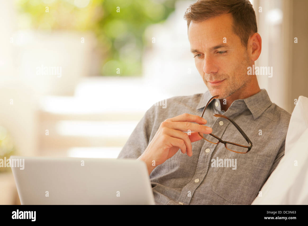 Mid adult man using laptop outdoors Stock Photo - Alamy
