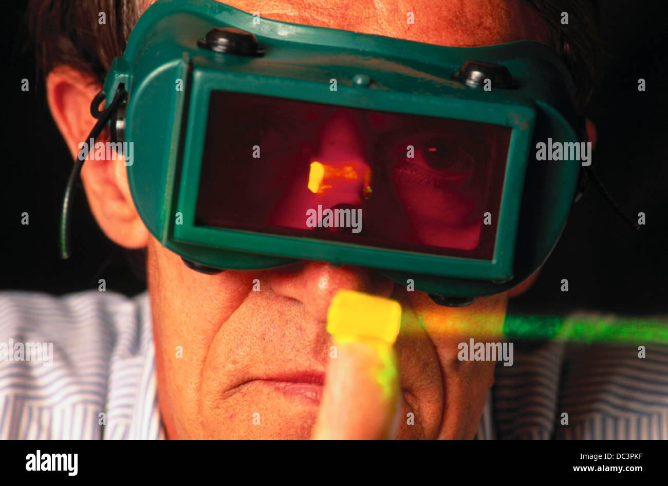 Scientist developing laser activated holographic memory storage device ...