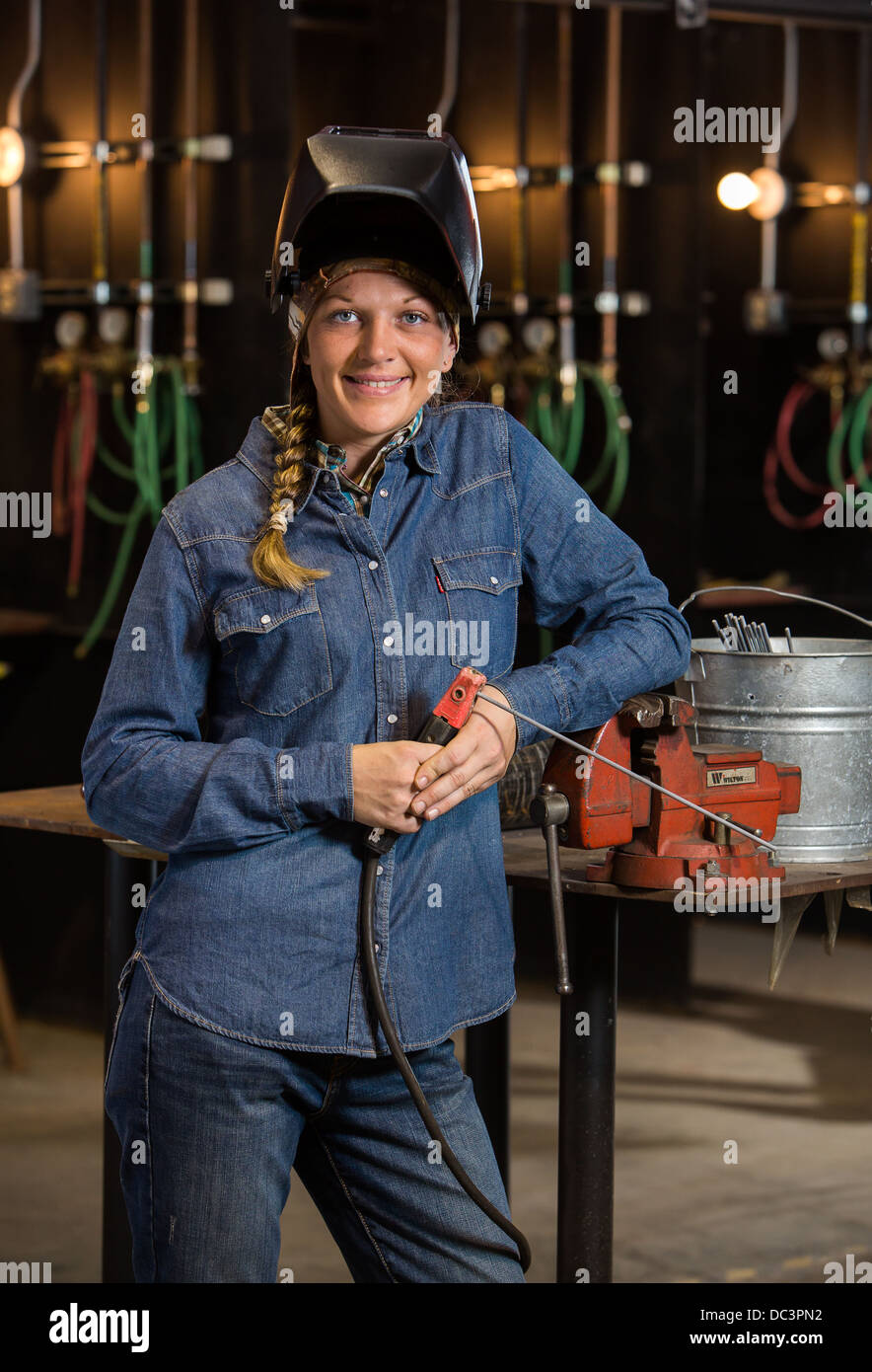 Female welder in industrial background Stock Photo - Alamy