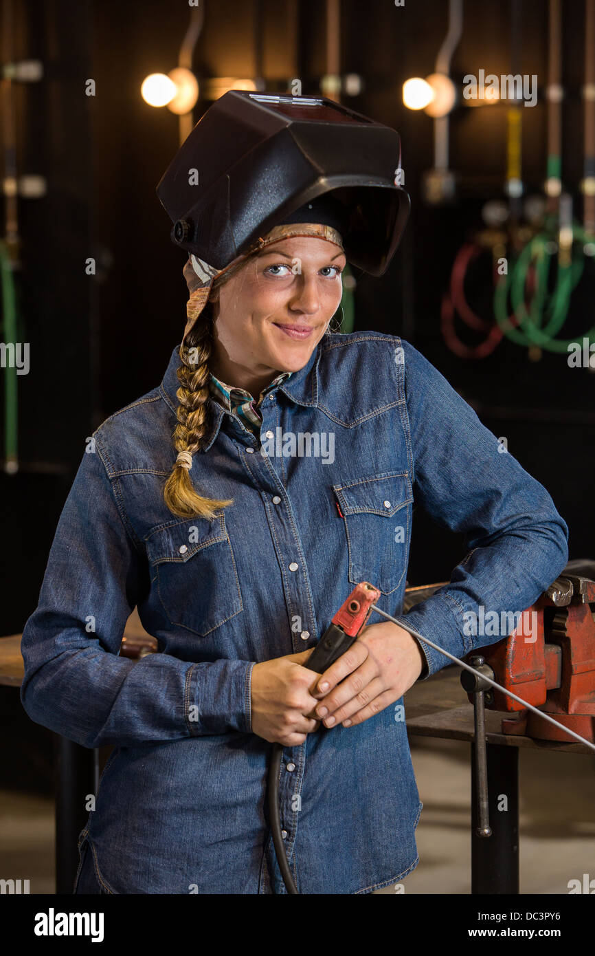Female welder in industrial background Stock Photo - Alamy