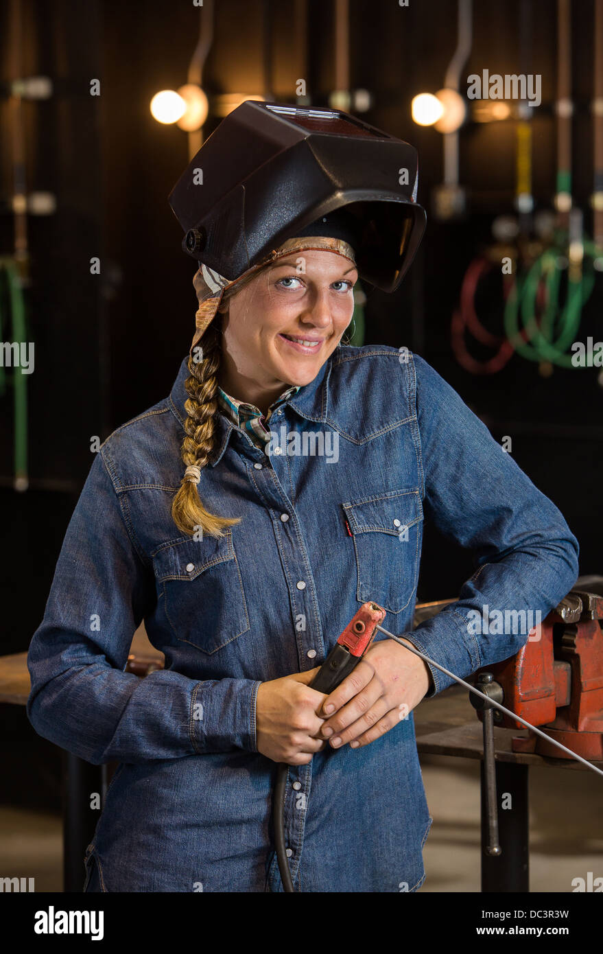 Female welder in industrial background Stock Photo - Alamy