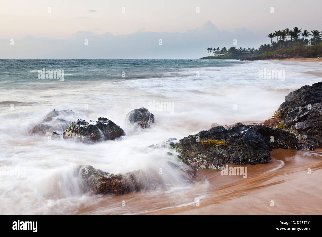 Rocks at sunset at Kamaole Beach in Maui, Hawaii with slight long ...