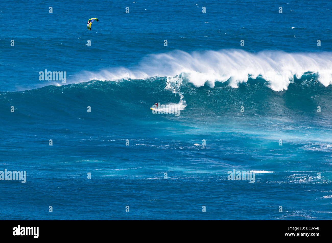 A kitesurfer in a tall wave at the famous surf spot Peahi Jaws in Maui ...