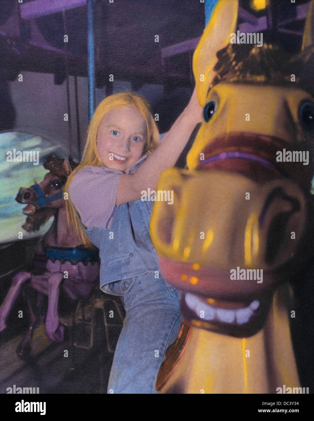 Young girl rides carousel Stock Photo - Alamy