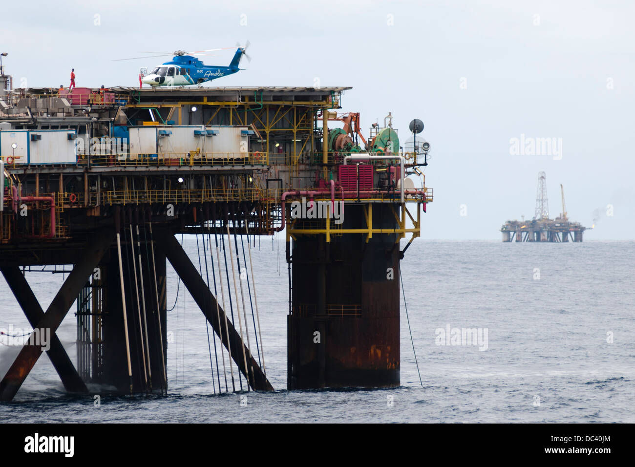 Offshore oil rig Petrobras VIII with helicopter landed/landing on deck ...