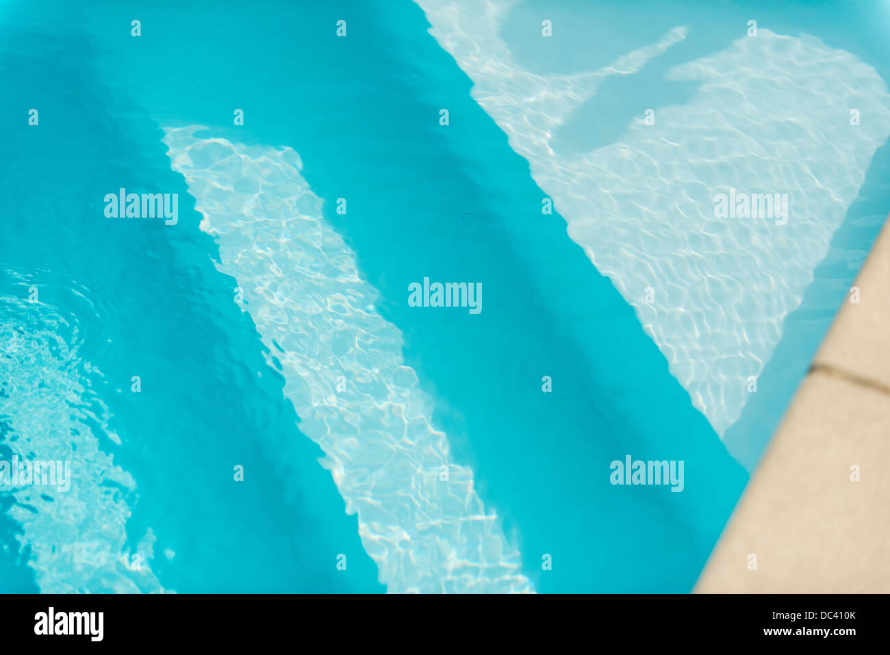 Steps in swimming pool in the sun Stock Photo - Alamy