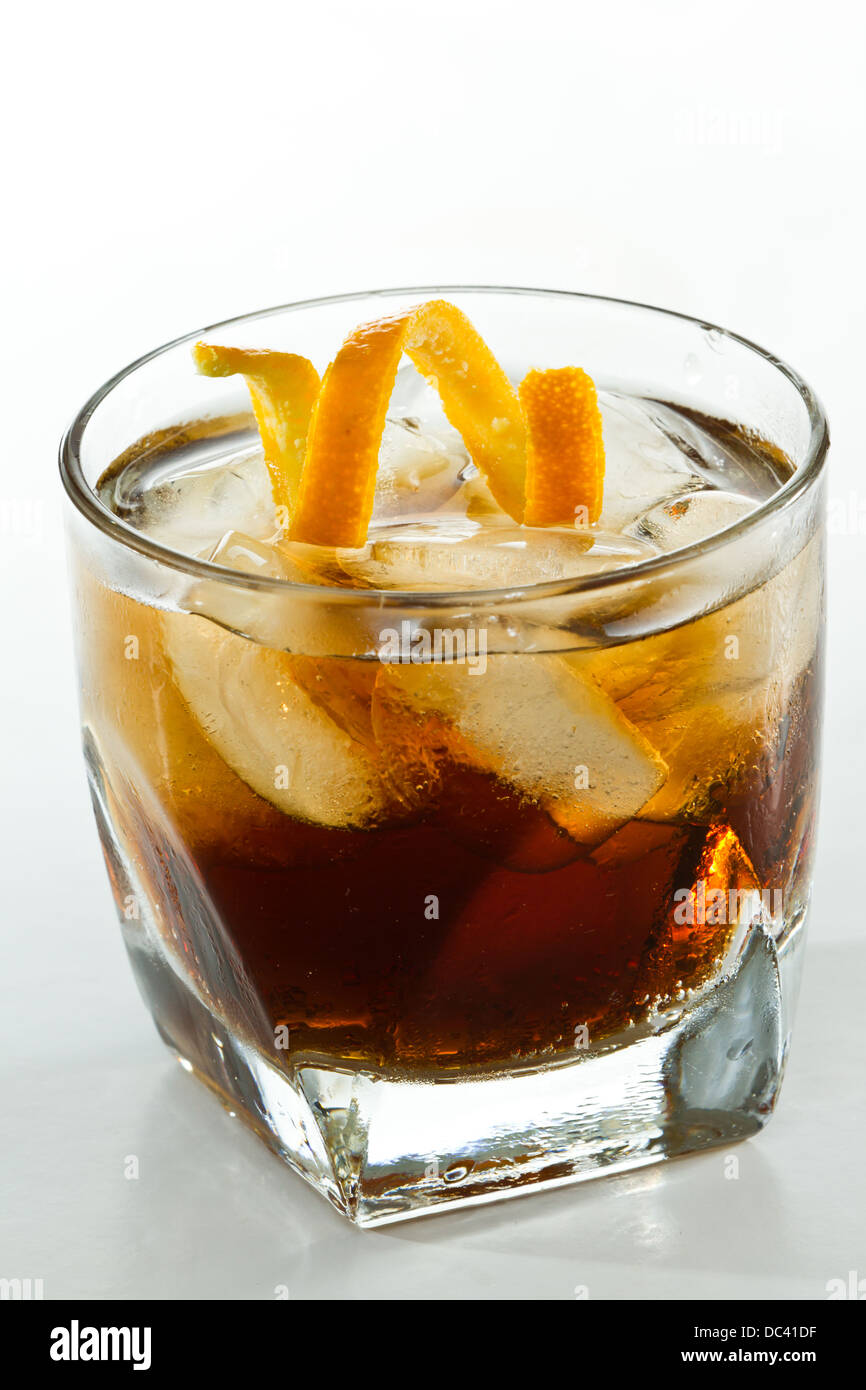 whiskey and cola cocktail served in a short glass garnished with an ...