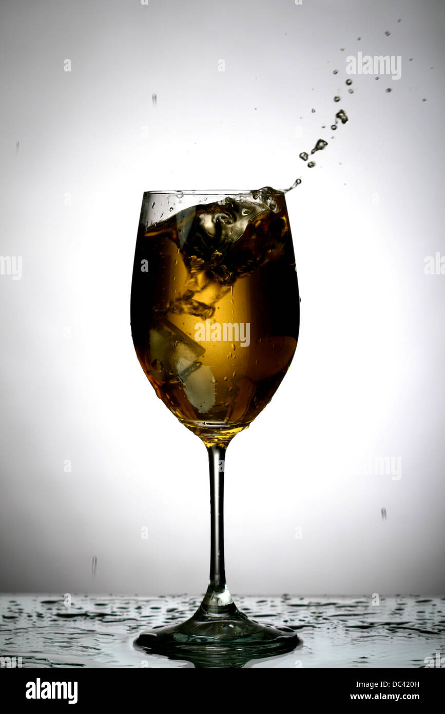 alcohol splash on gray background Stock Photo - Alamy