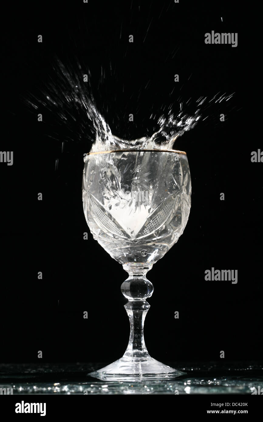 alcohol splash on black background Stock Photo - Alamy