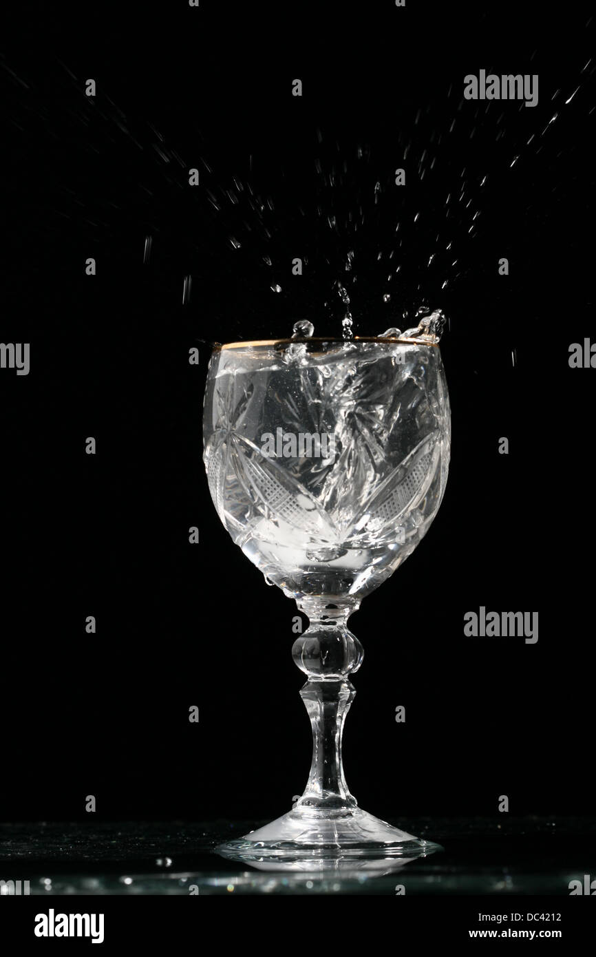 alcohol splash on black background Stock Photo - Alamy