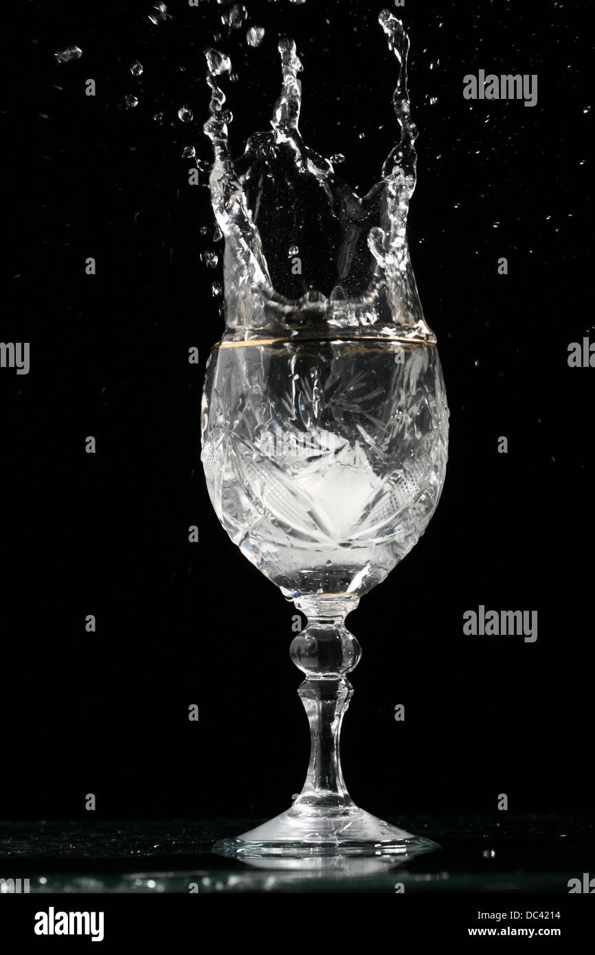 alcohol splash on black background Stock Photo - Alamy