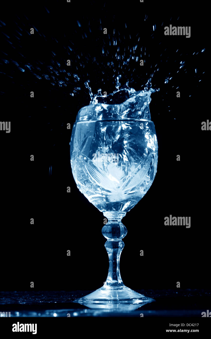 alcohol splash on black background Stock Photo - Alamy
