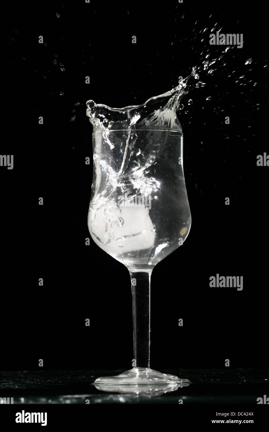 alcohol splash on black background Stock Photo - Alamy
