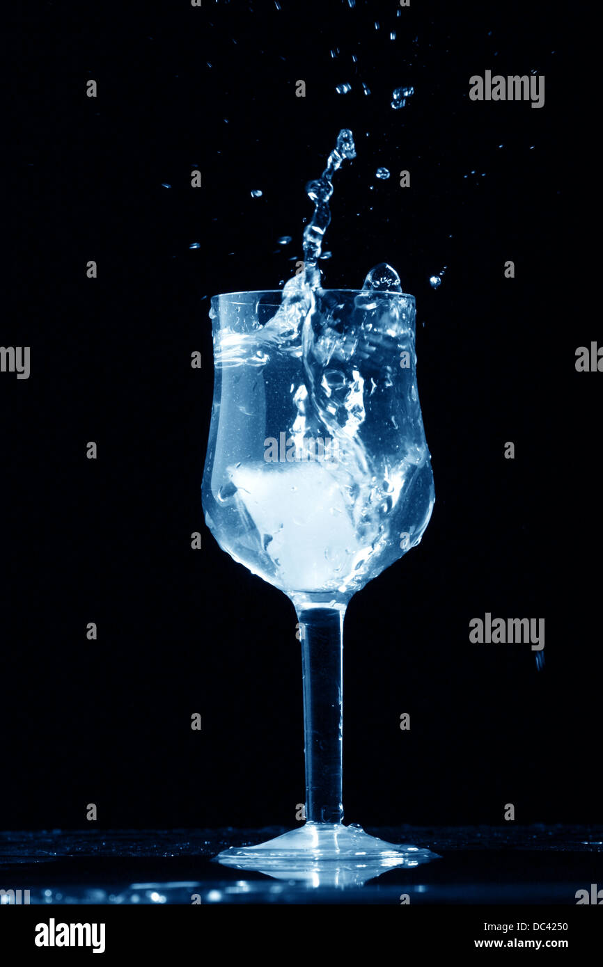alcohol splash on black background Stock Photo - Alamy