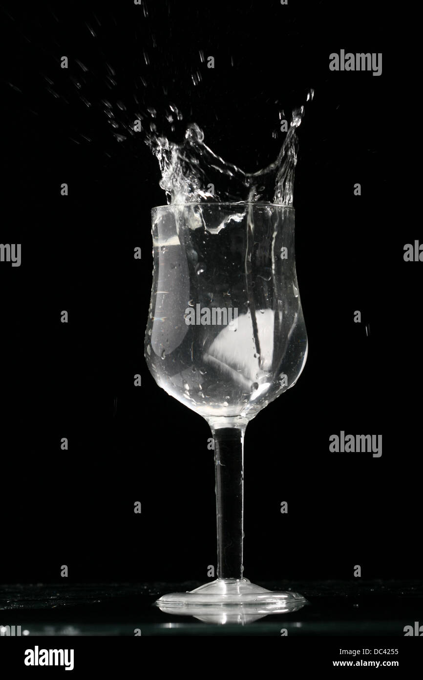 alcohol splash on black background Stock Photo - Alamy