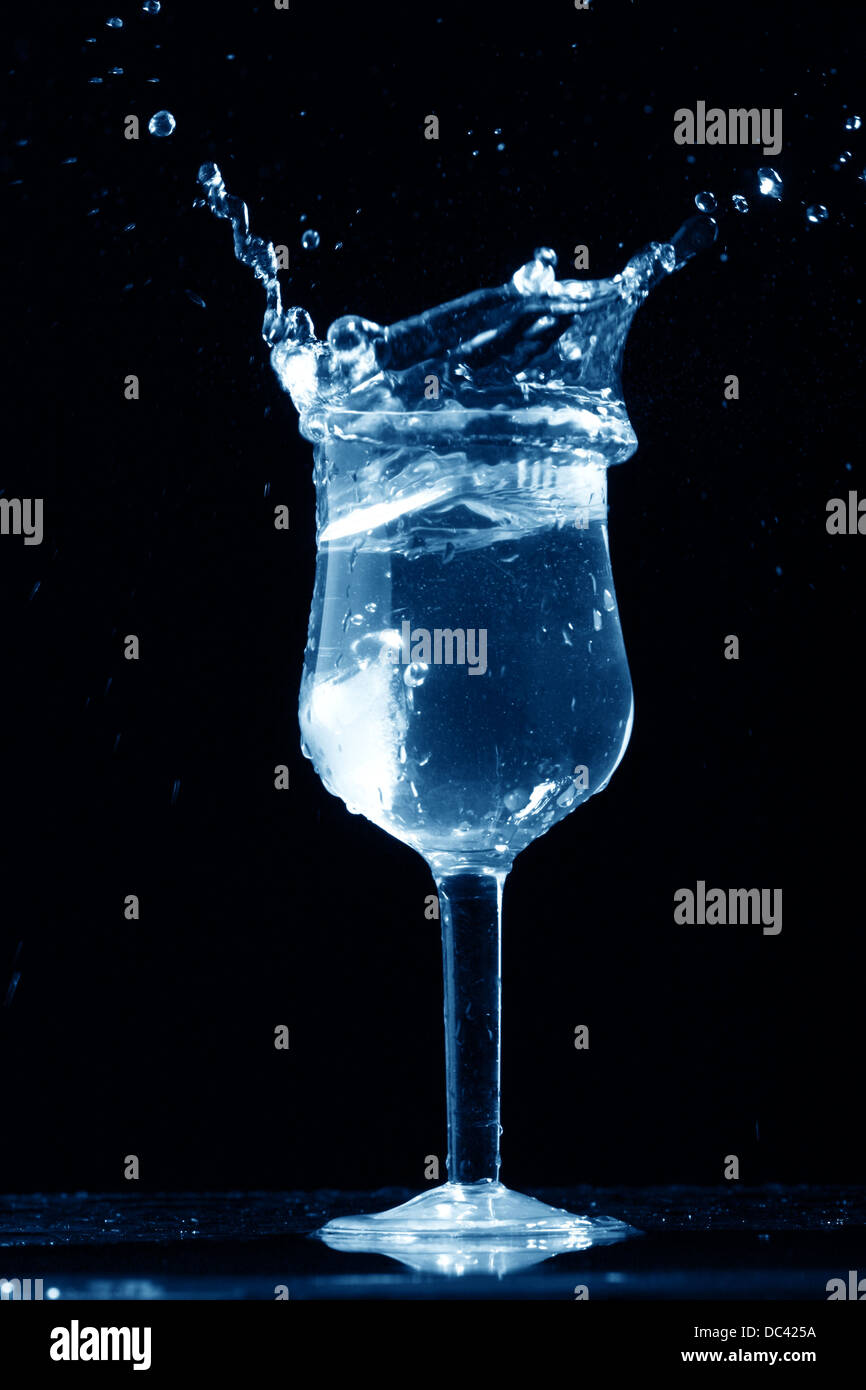 alcohol splash on black background Stock Photo - Alamy