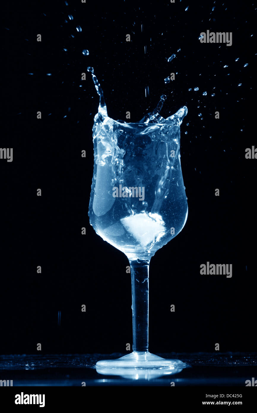 alcohol splash on black background Stock Photo - Alamy