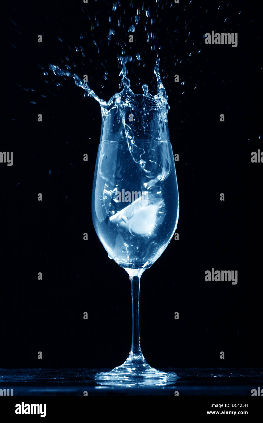 alcohol splash on black background Stock Photo - Alamy