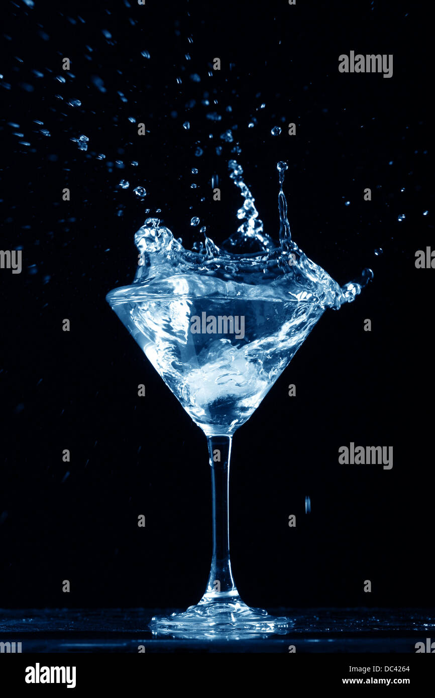 alcohol splash on black background Stock Photo - Alamy