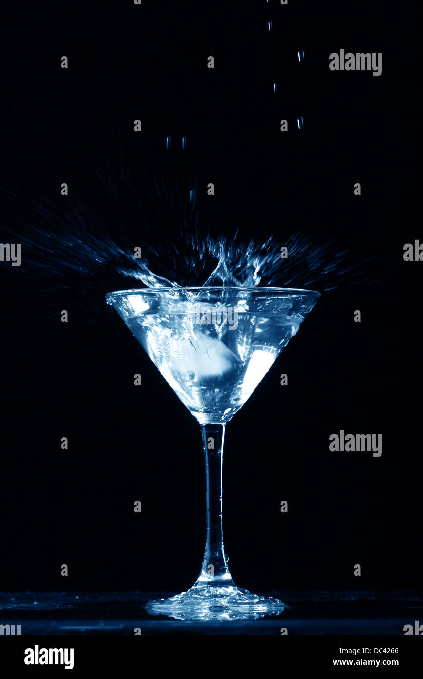 alcohol splash on black background Stock Photo - Alamy