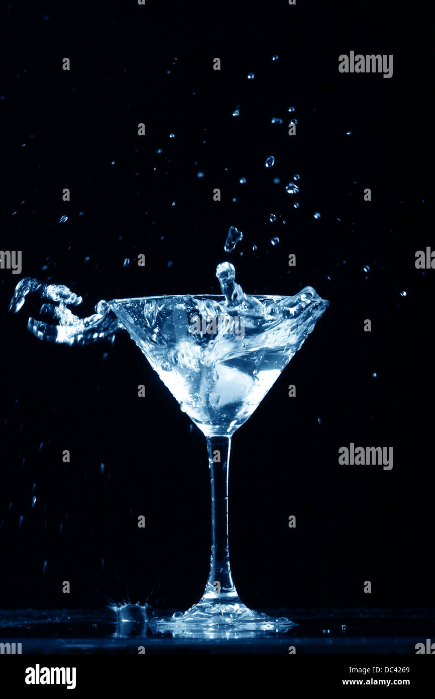 alcohol splash on black background Stock Photo - Alamy