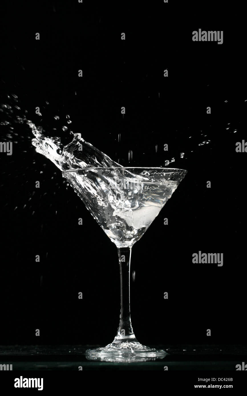 alcohol splash on black background Stock Photo - Alamy