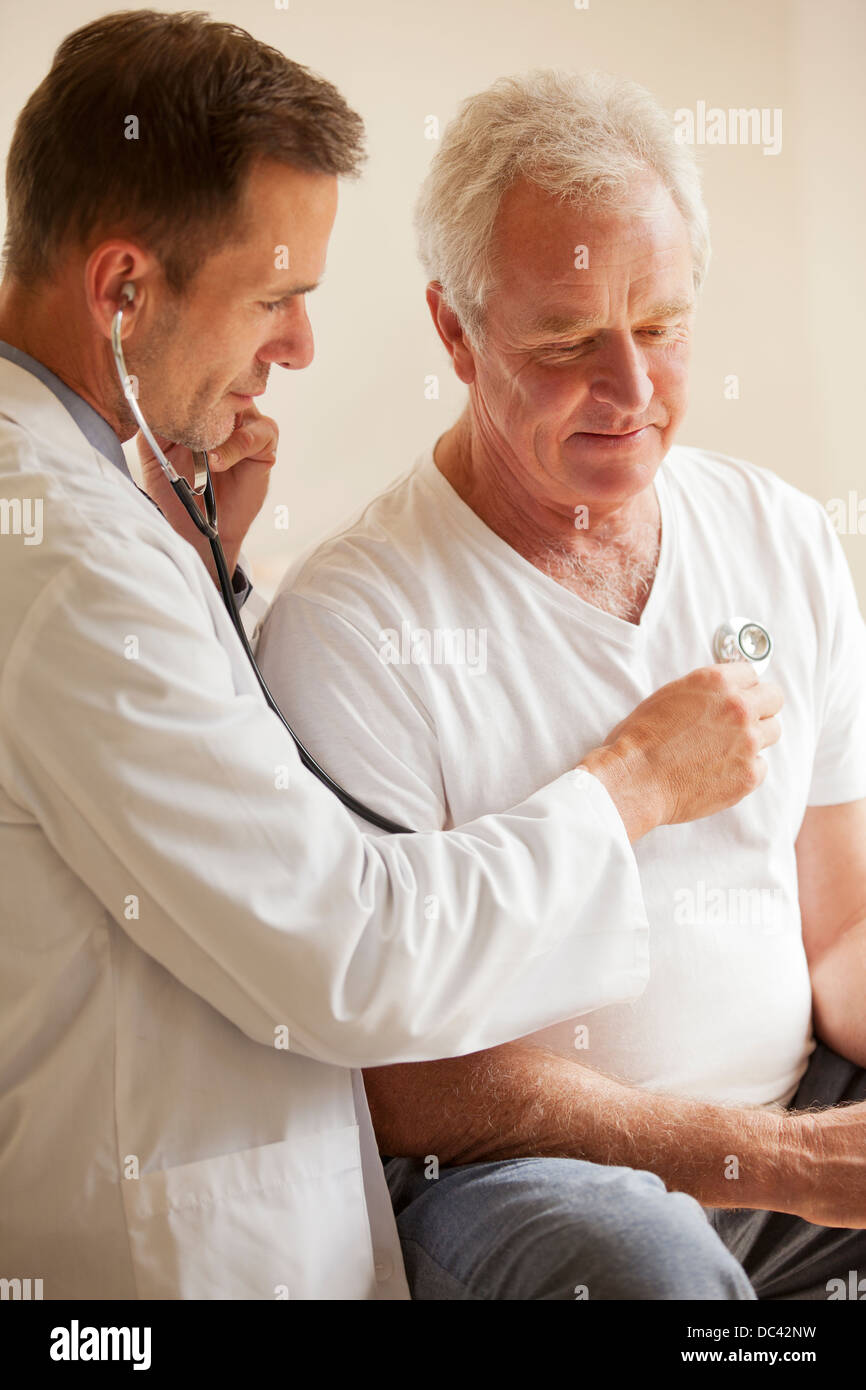 Doctor checking senior man's heart with stethoscope Stock Photo - Alamy