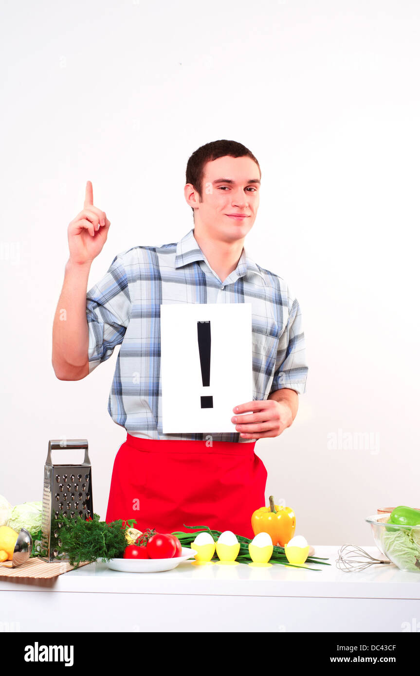 portrait of a young man, hold exclamation mark Stock Photo - Alamy