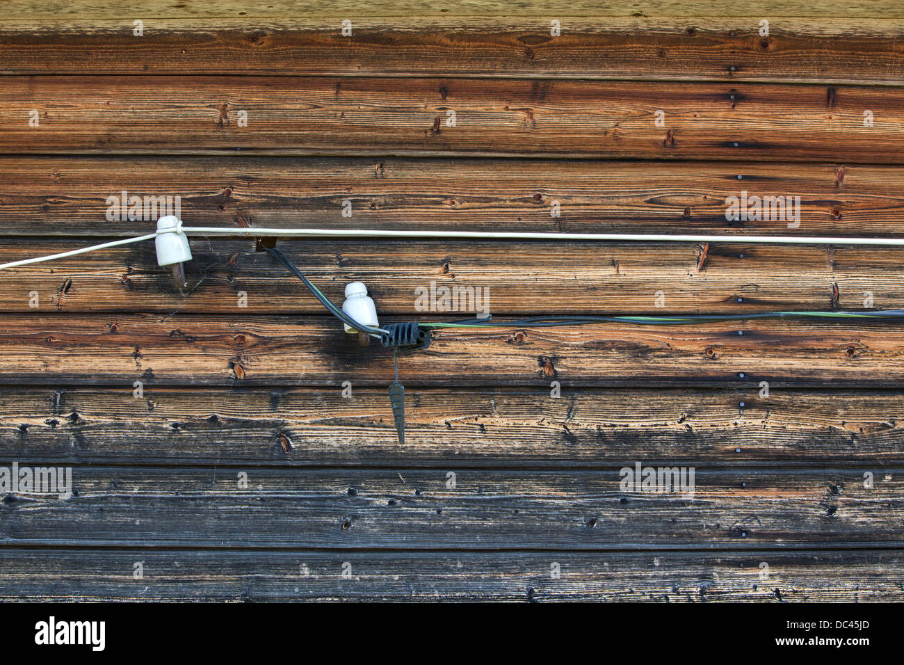 Old wood wall and power line in a village Stock Photo - Alamy