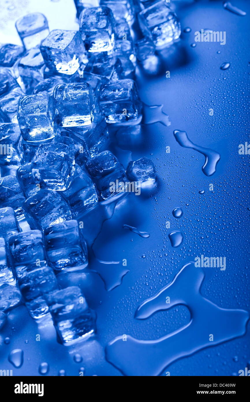 Ice cubes on blue background Stock Photo - Alamy