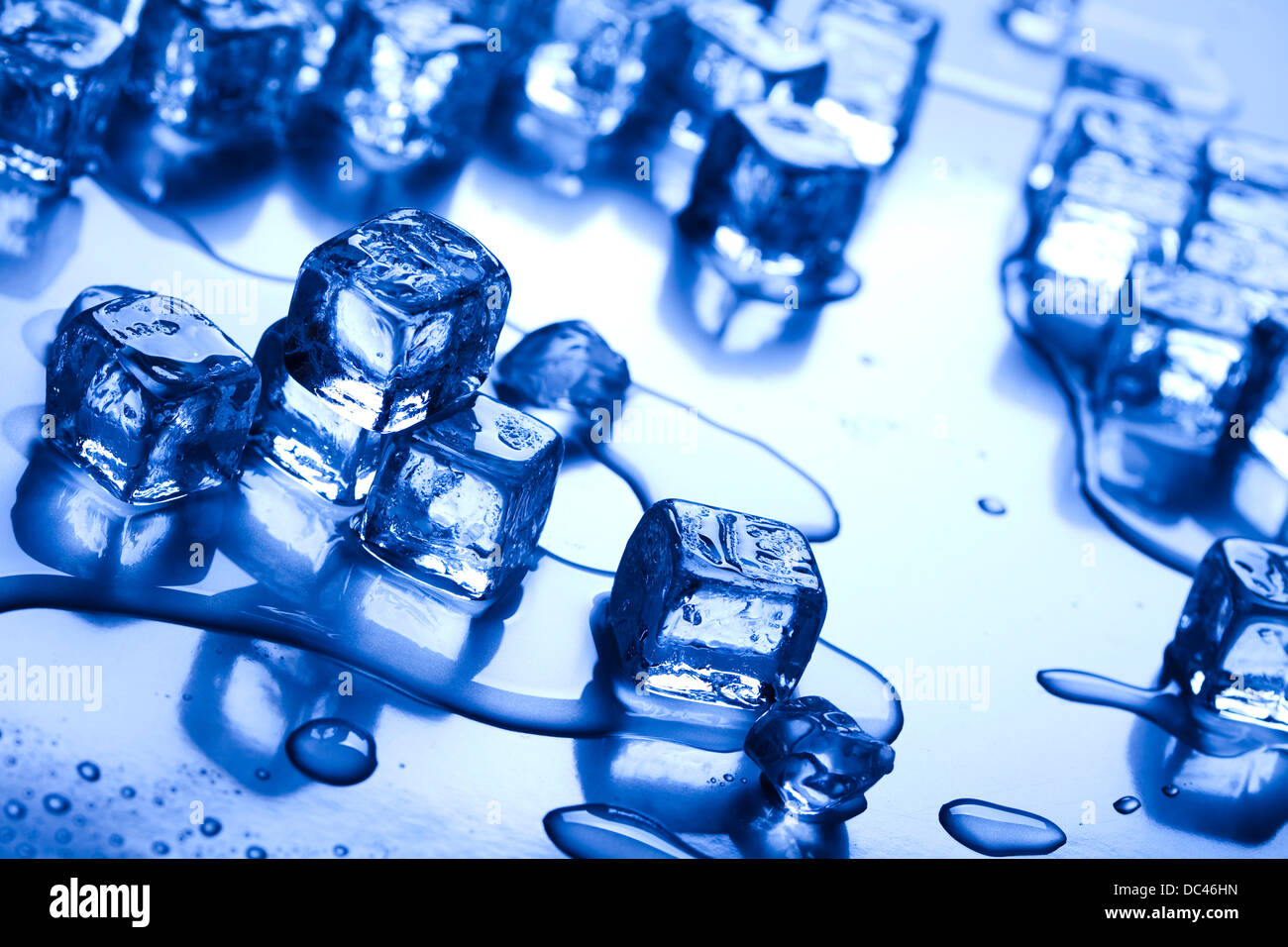 Ice cubes on blue background Stock Photo - Alamy