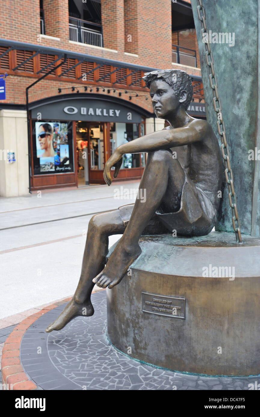 Statue of a boy and a prow of a ship, Gunwharf Quays, Portsmouth, UK ...