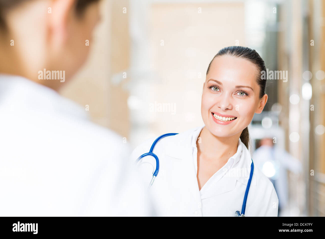 two doctors talking in the lobby Stock Photo - Alamy