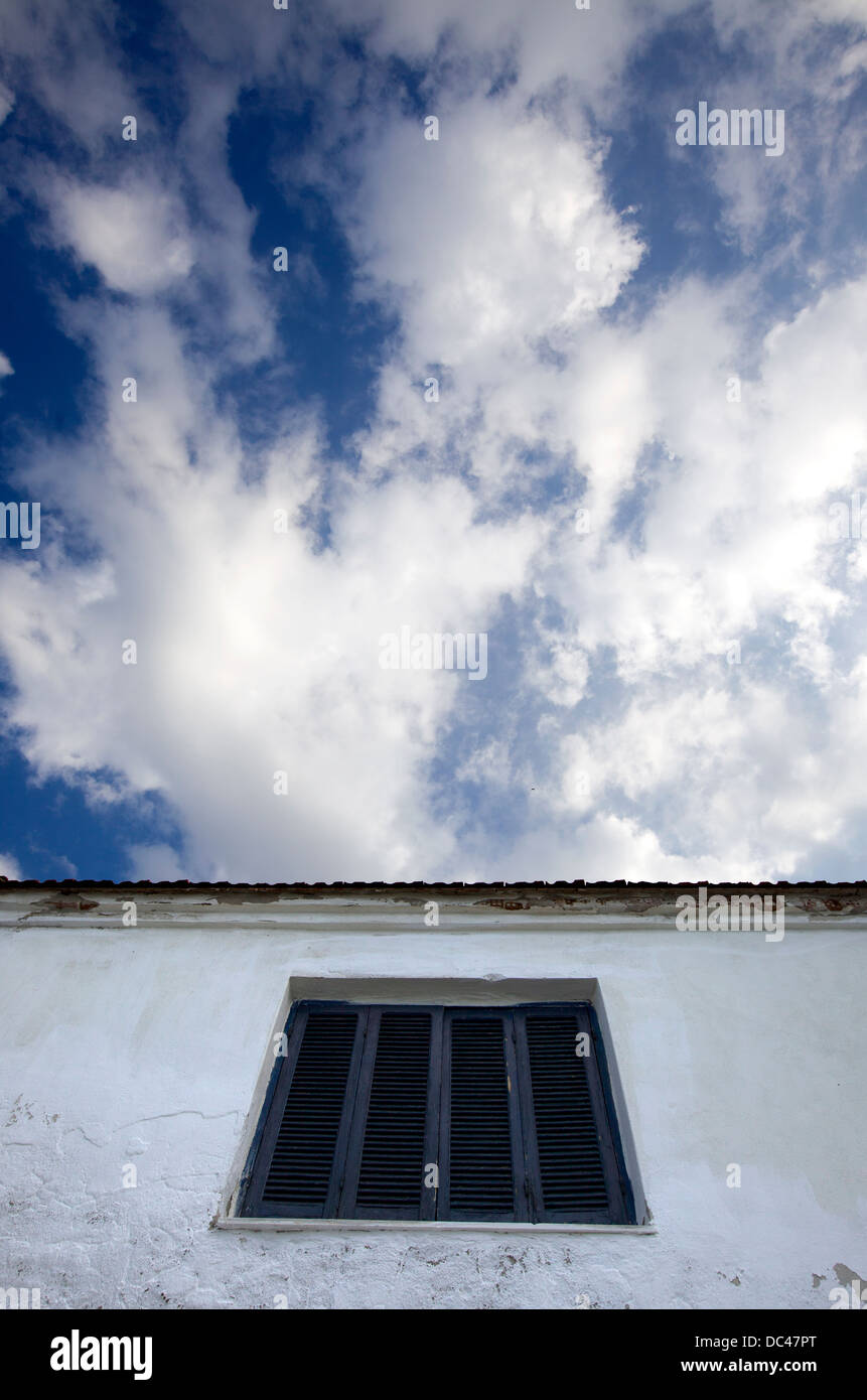 A window with blue sky in background Stock Photo - Alamy
