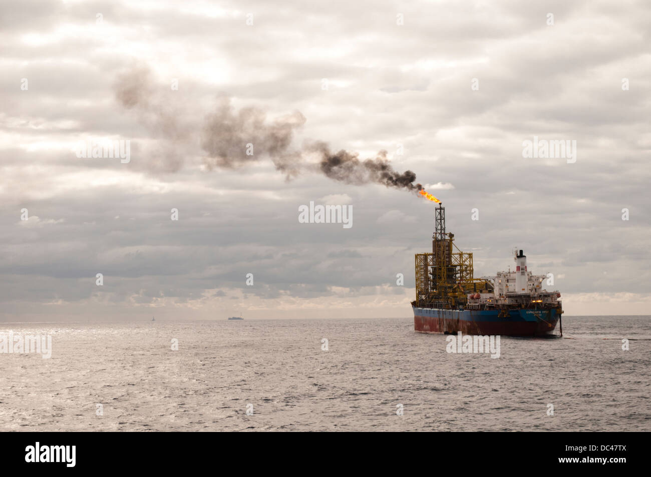 Espadarte FPSO oil rig far at horizon blowing smoke to atmosphere in ...