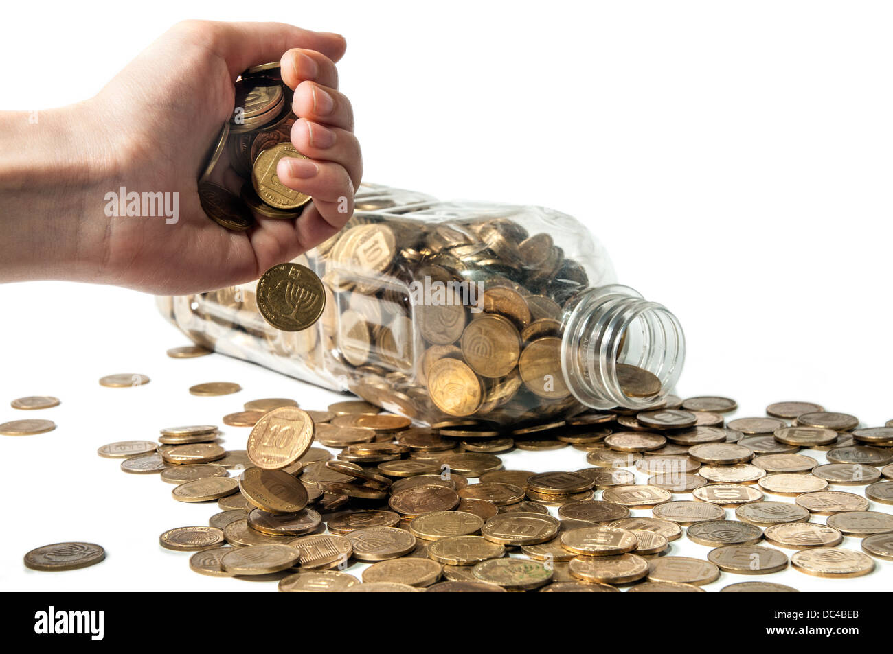 Human hand is pouring the coins, white background Stock Photo - Alamy