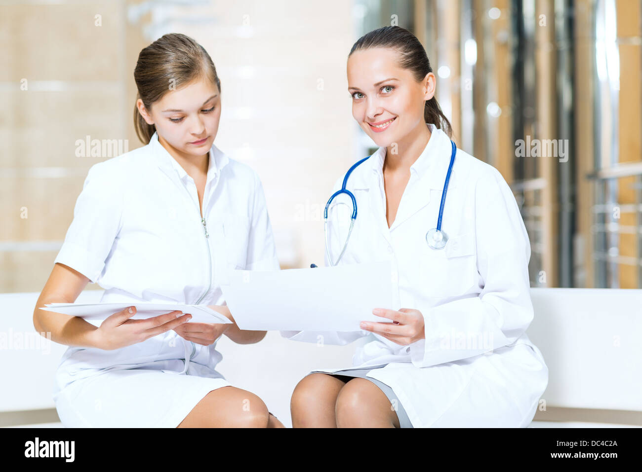 two doctors talking in the lobby of the hospital Stock Photo - Alamy
