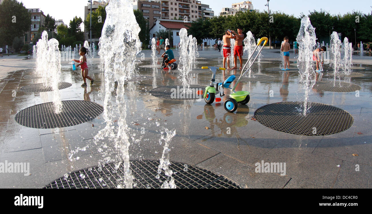 Kids refresh playing over floor fountains during a heat wave with ...