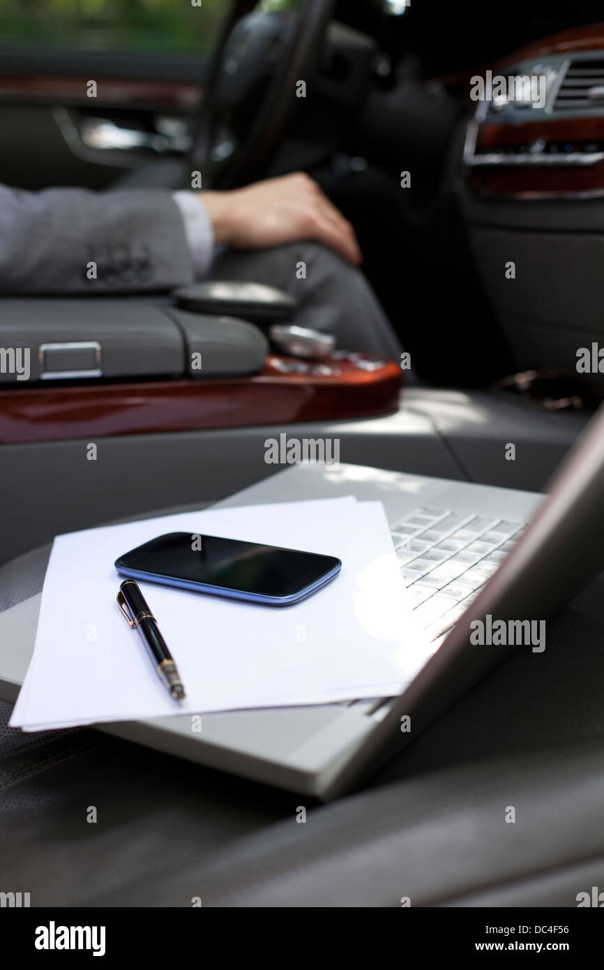 Laptop and mobile phone on car seat Stock Photo - Alamy