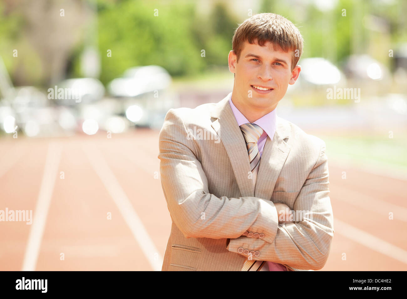 Businessman at athletic stadium and race track Stock Photo - Alamy
