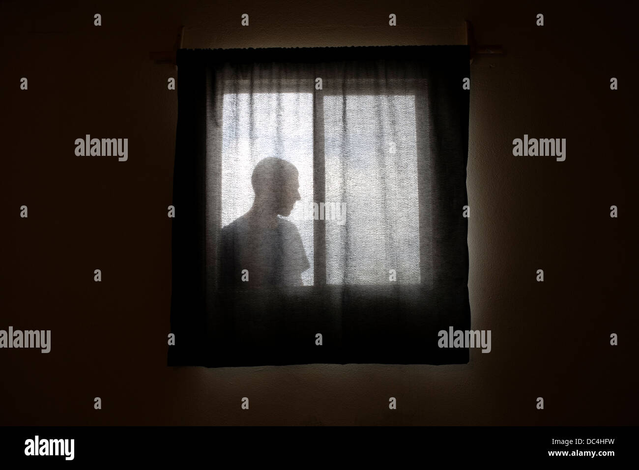 Silhouette man opening curtains looking hi-res stock photography and ...