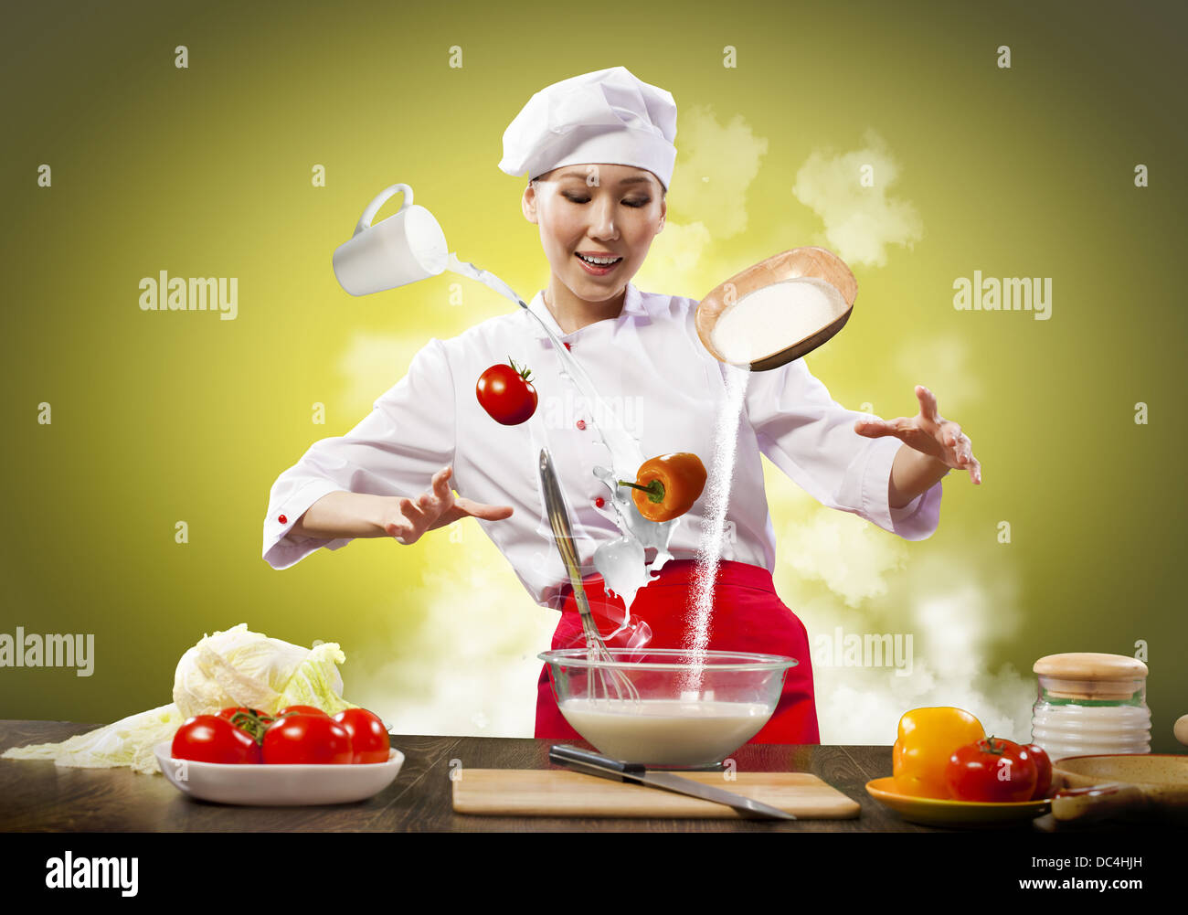 Asian female cooking with magic Stock Photo - Alamy