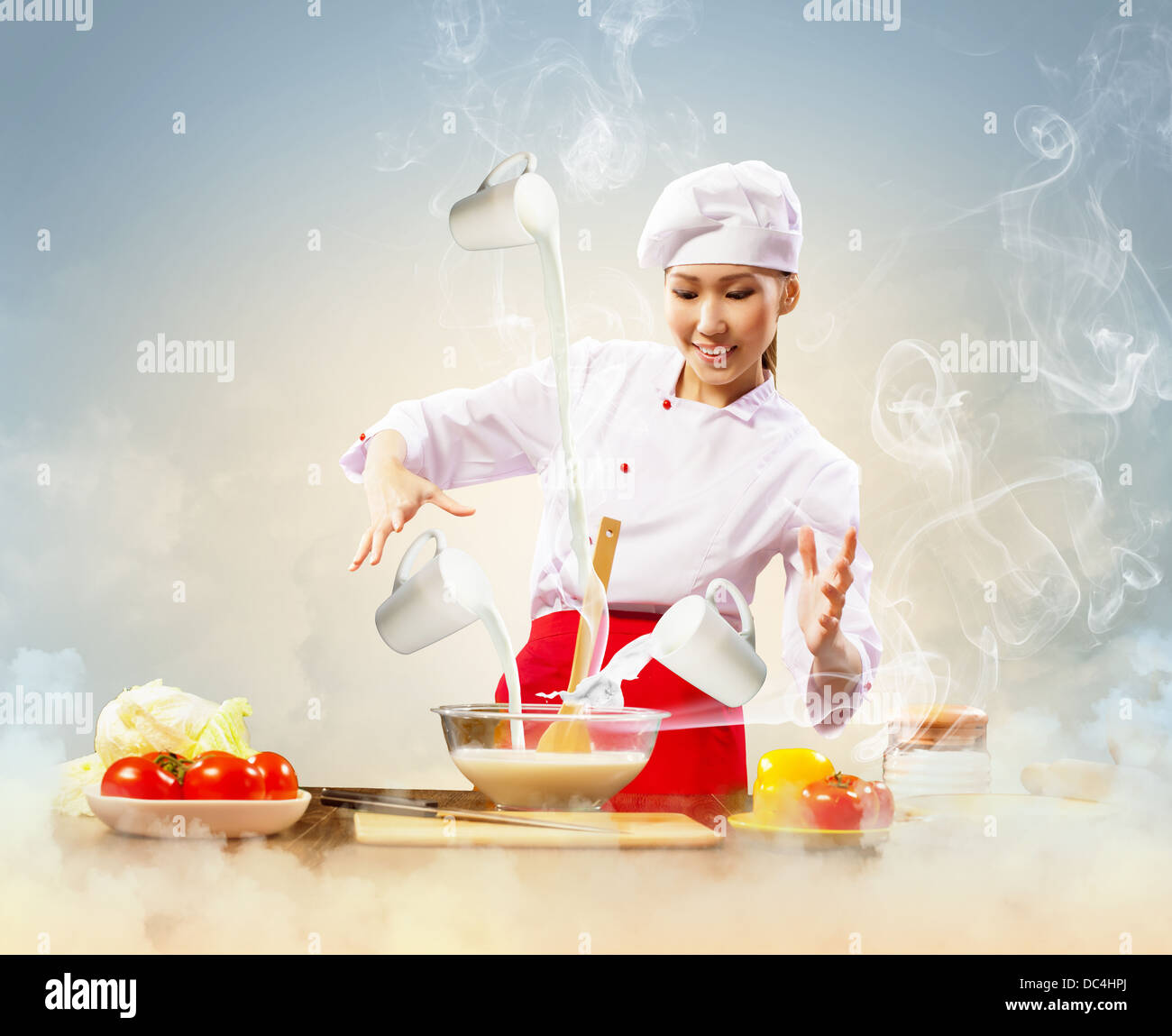 Asian female cooking with magic Stock Photo - Alamy