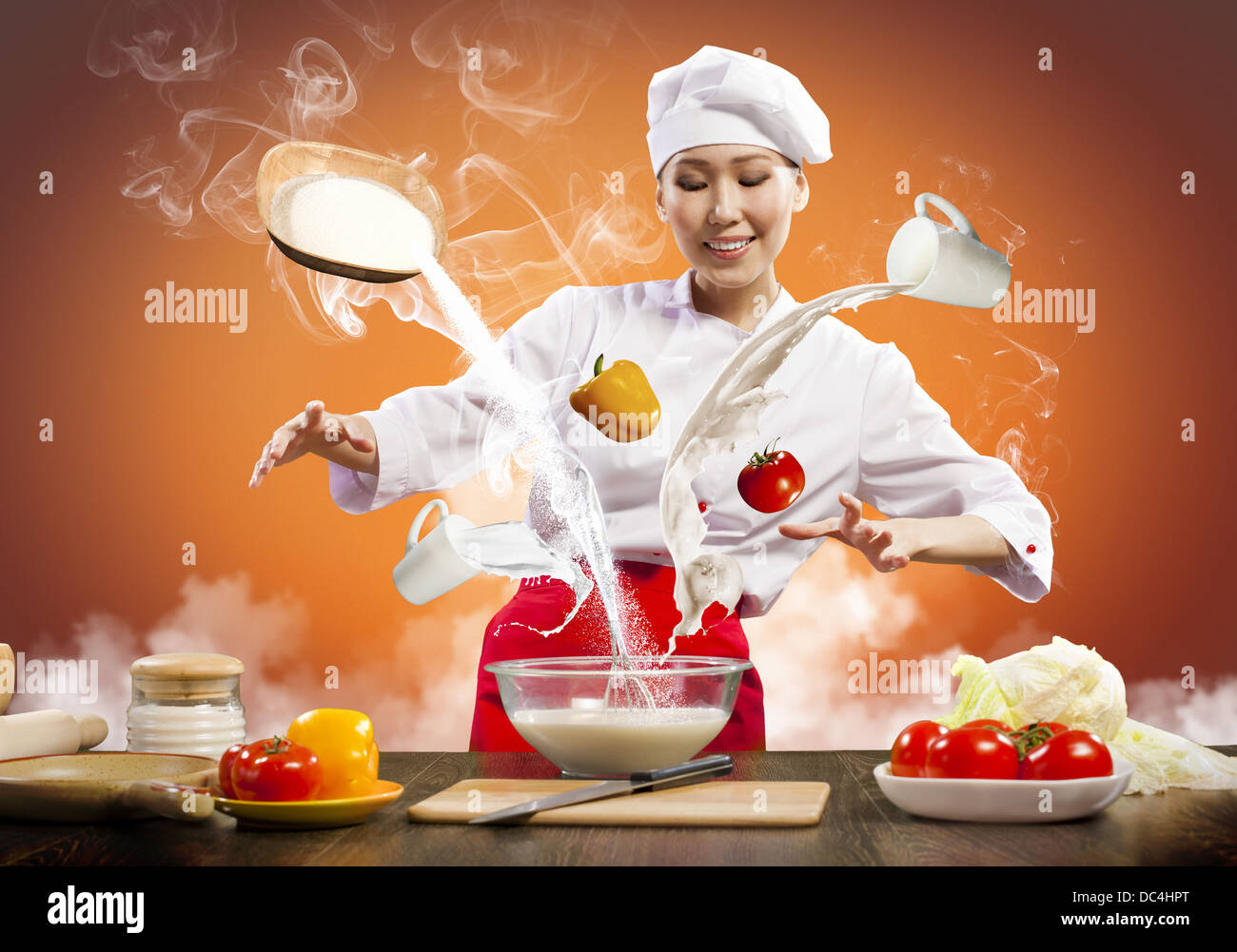 Asian female cooking with magic Stock Photo - Alamy