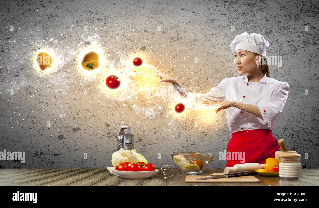 Asian female cooking with magic Stock Photo - Alamy