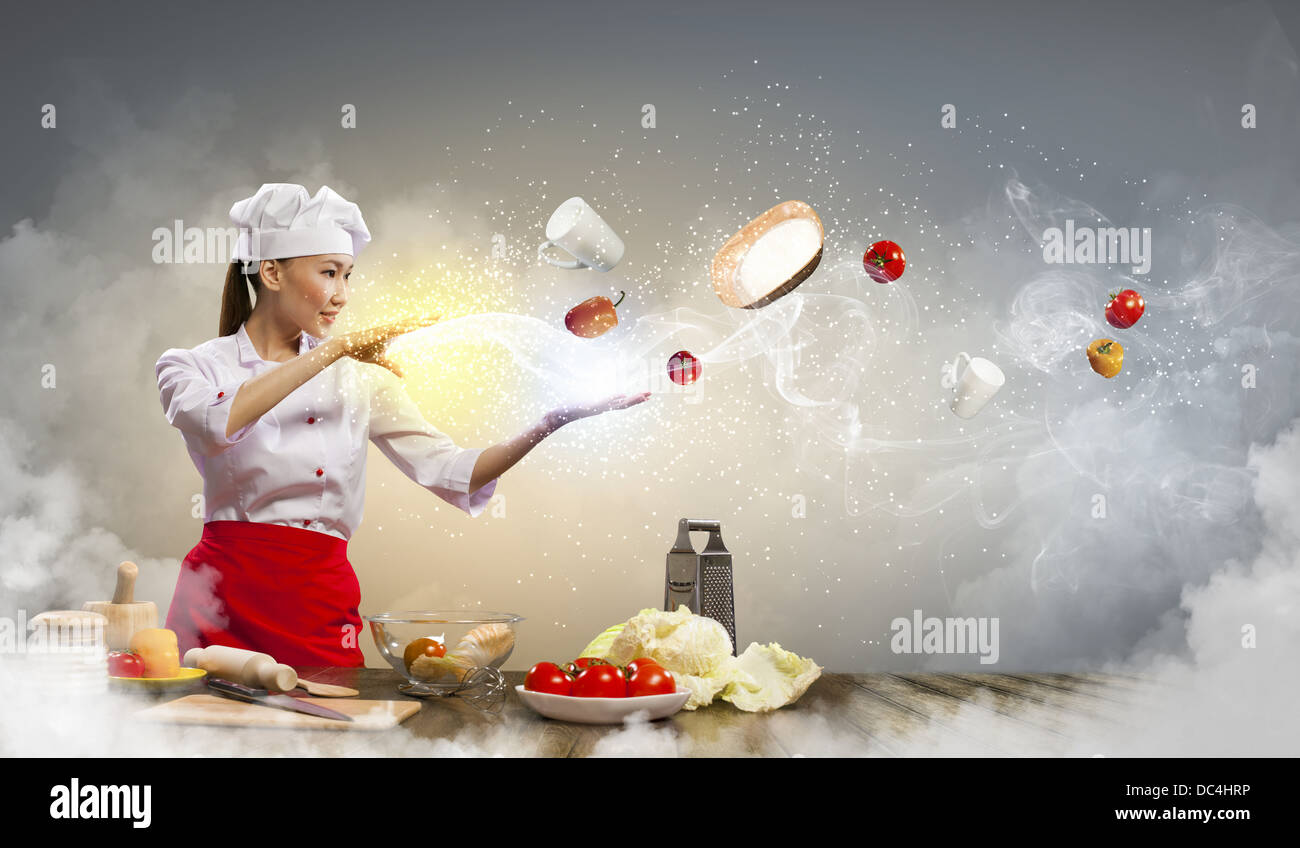 Asian female cooking with magic Stock Photo - Alamy
