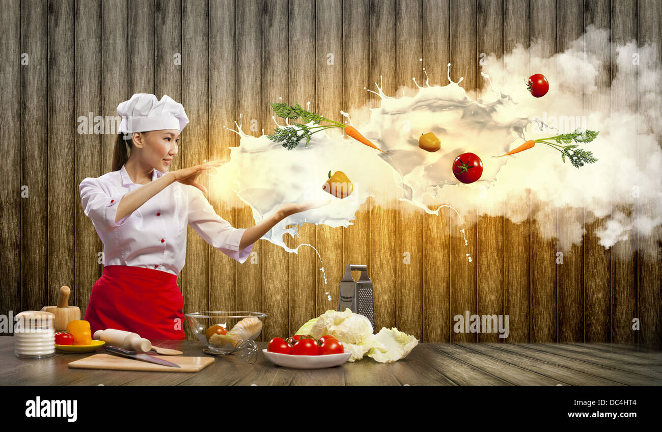 Asian female cooking with magic Stock Photo - Alamy