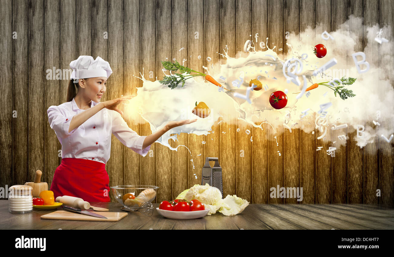 Asian female cooking with magic Stock Photo - Alamy